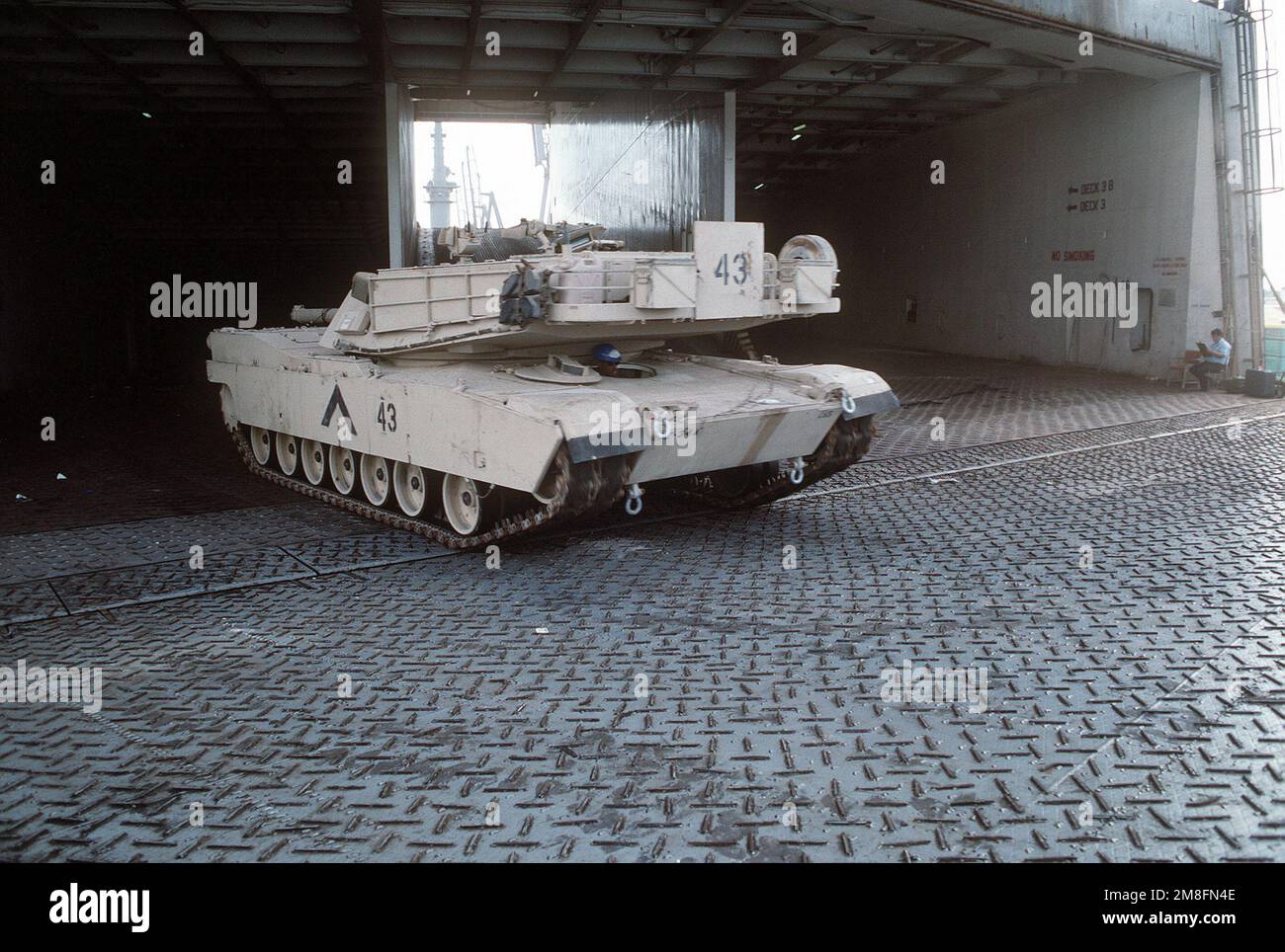 An M-1A1 Abrams main battle tank waits on the stern ramp of the ...