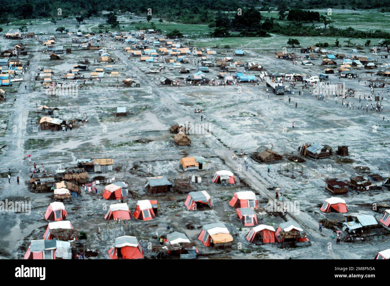 Tents are set up as temporary shelters in an area devasteated by the ...