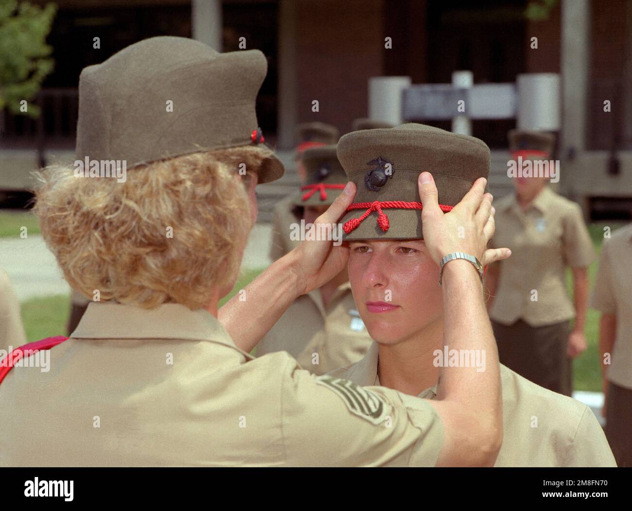 A drill instructor replaces a 4th Battalion recruit's cover after ...