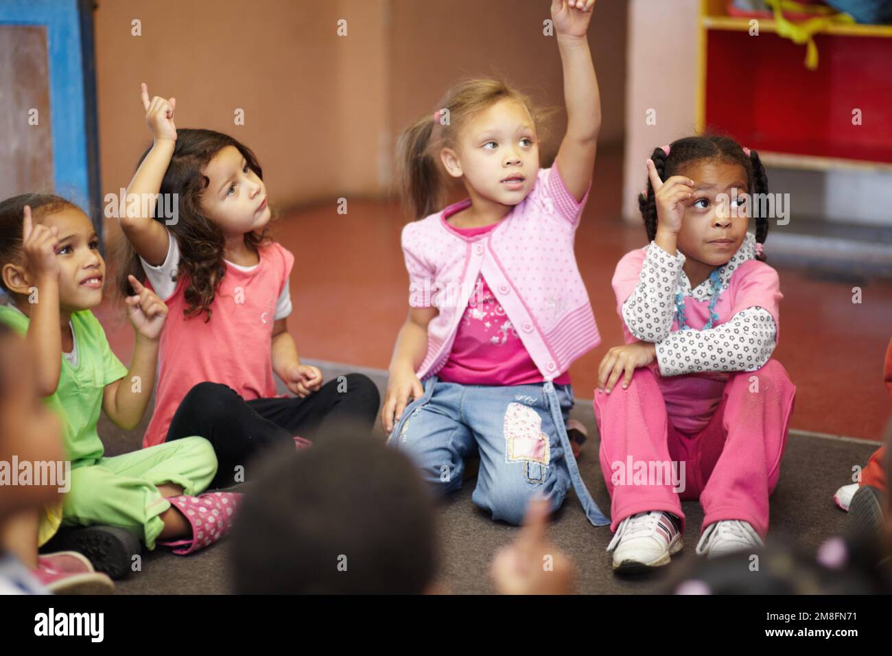Kids put hands up classroom hi-res stock photography and images - Alamy