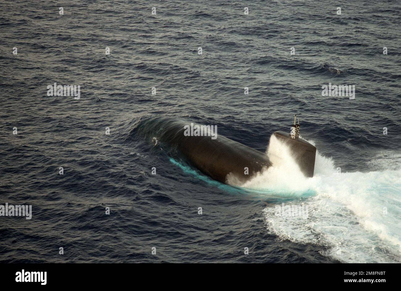 Water falls from the sail of the nuclear-powered attack submarine USS ...