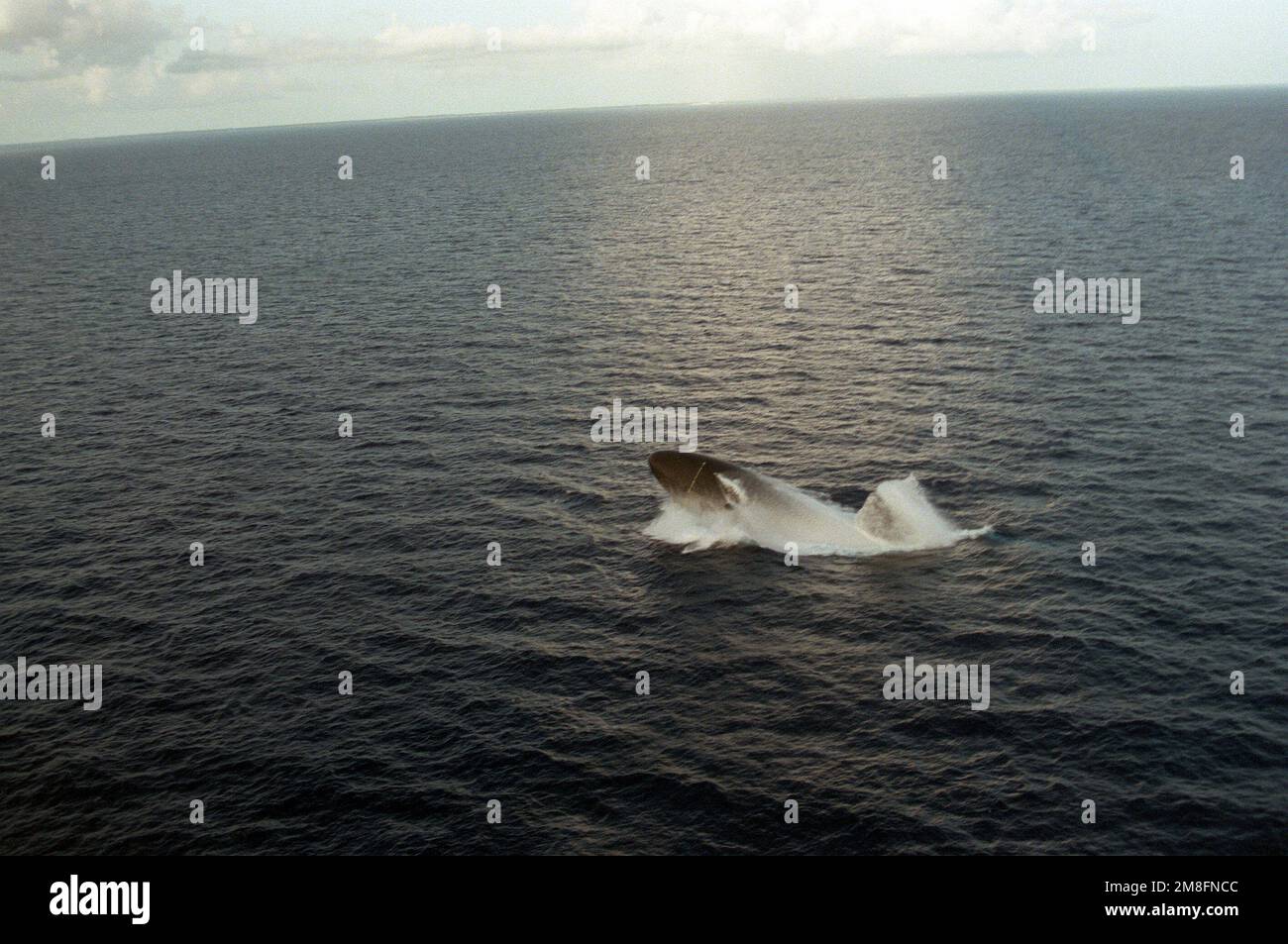 Water cascades off the sail of the nuclear-powered attack submarine USS ...