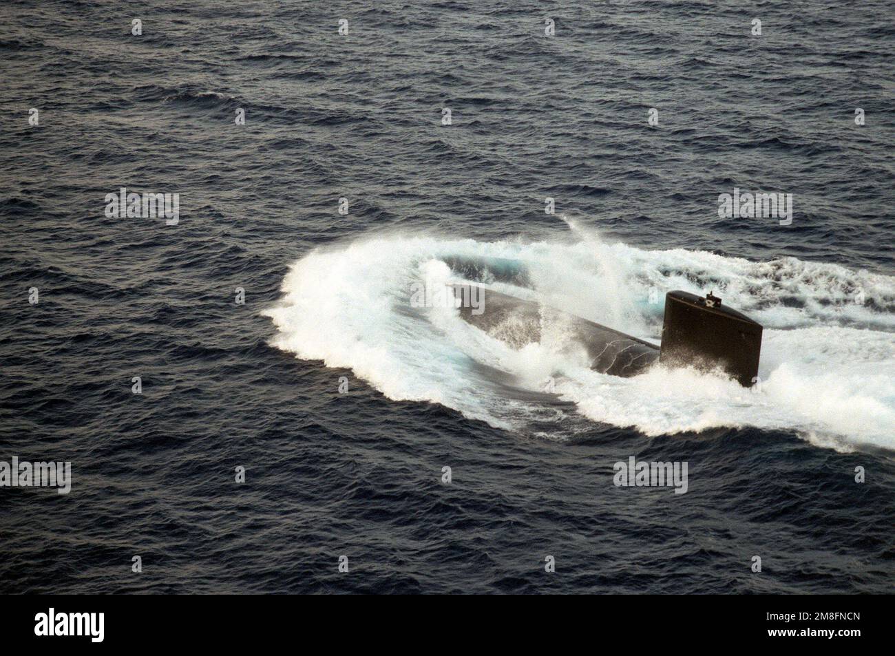 The nuclear-powered attack submarine USS ALEXANDRIA (SSN-757) surfaces ...