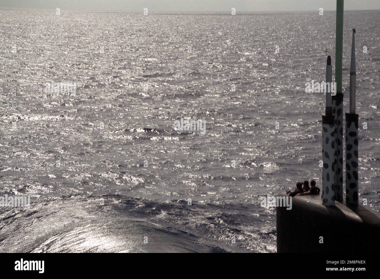 Crew members stand watch at the top of the sail of the nuclear-powered ...