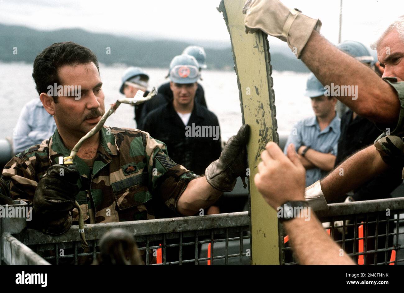 Two U.S. Air Force crash investigators inspect a piece of debris aboard ...