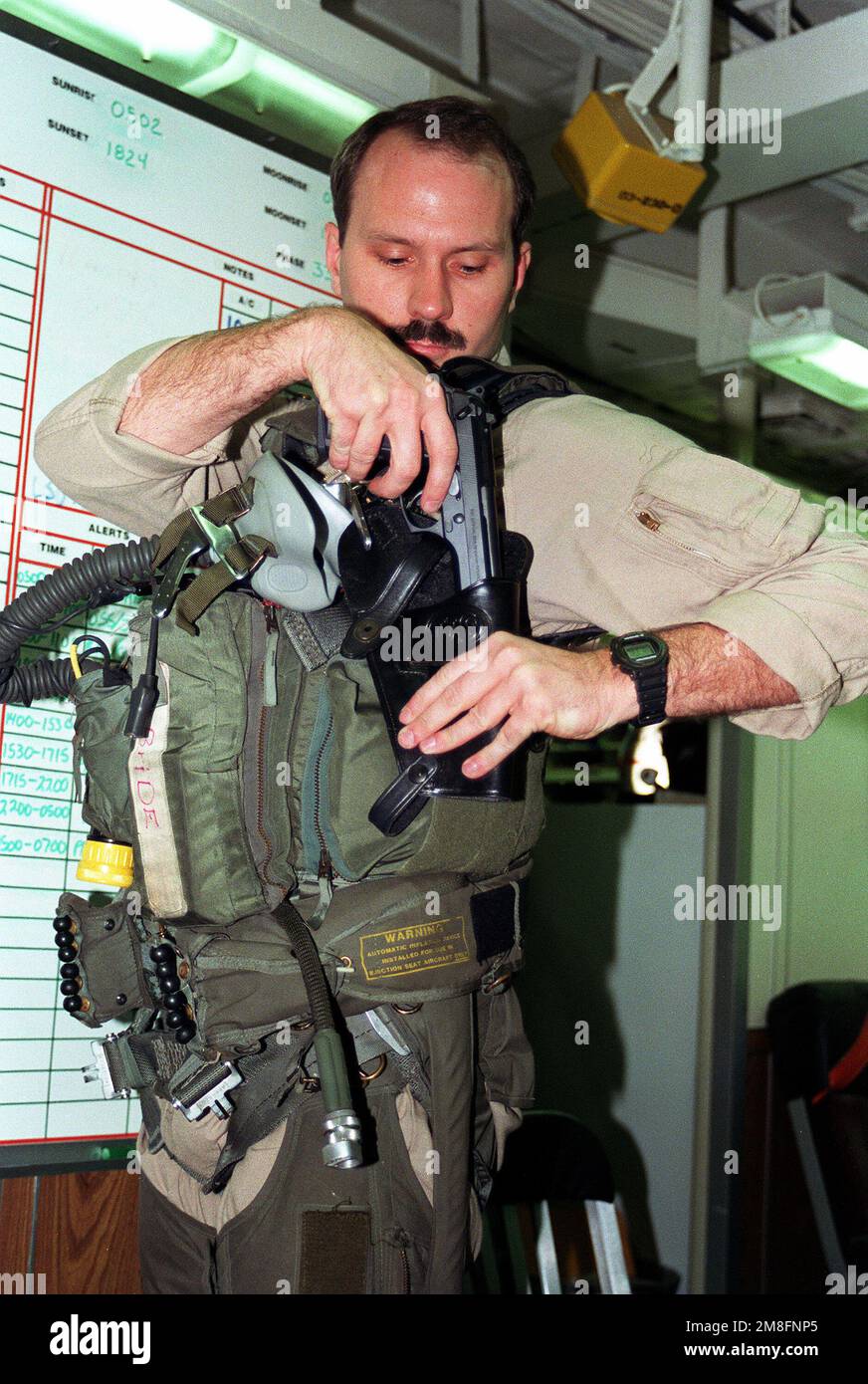 LT. CMDR. Kelly McBride of Fighter Squadron 114 (VF-114) arms himself ...