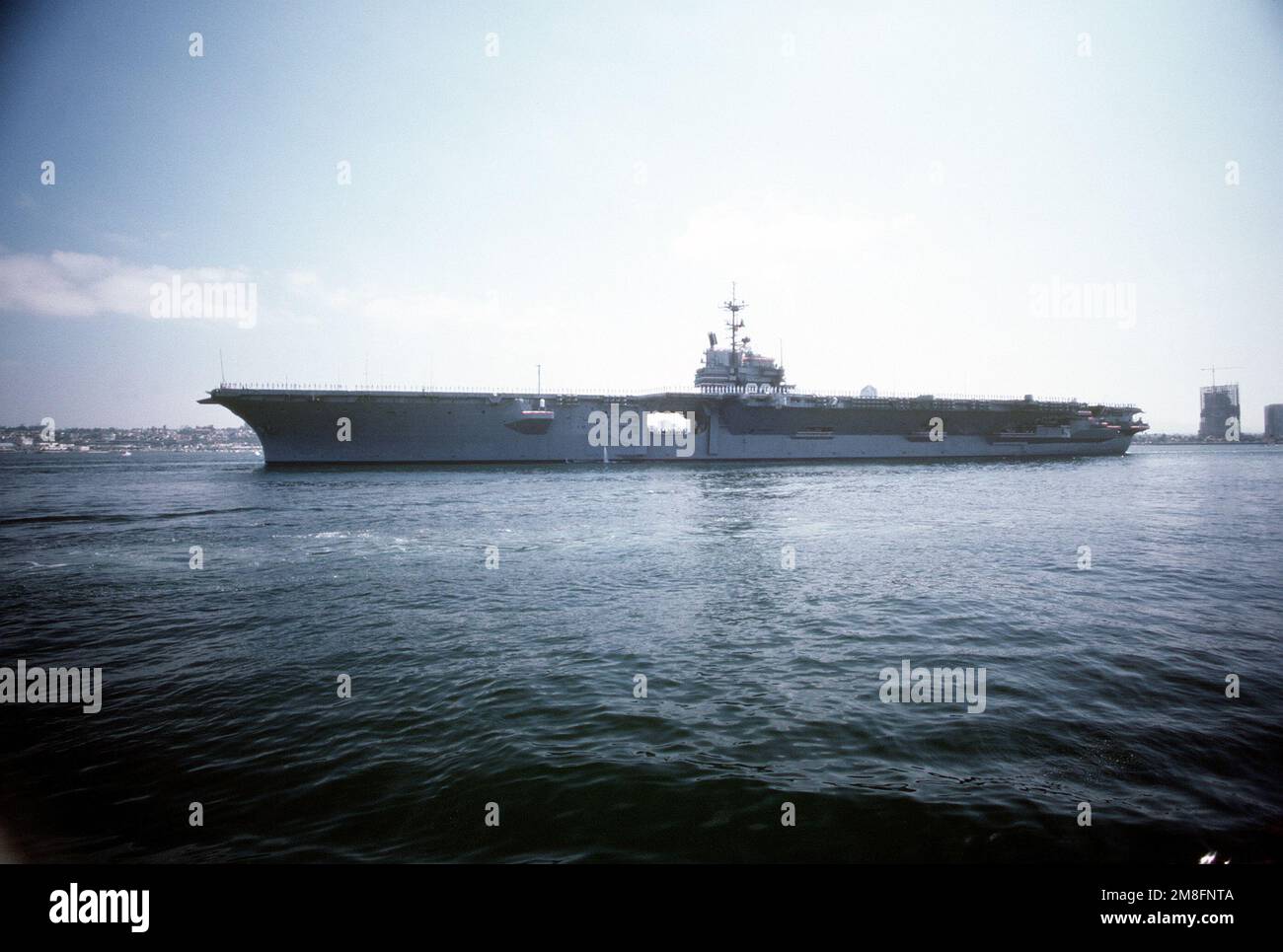 With its crew manning the rails, the aircraft carrier USS INDEPENDENCE ...