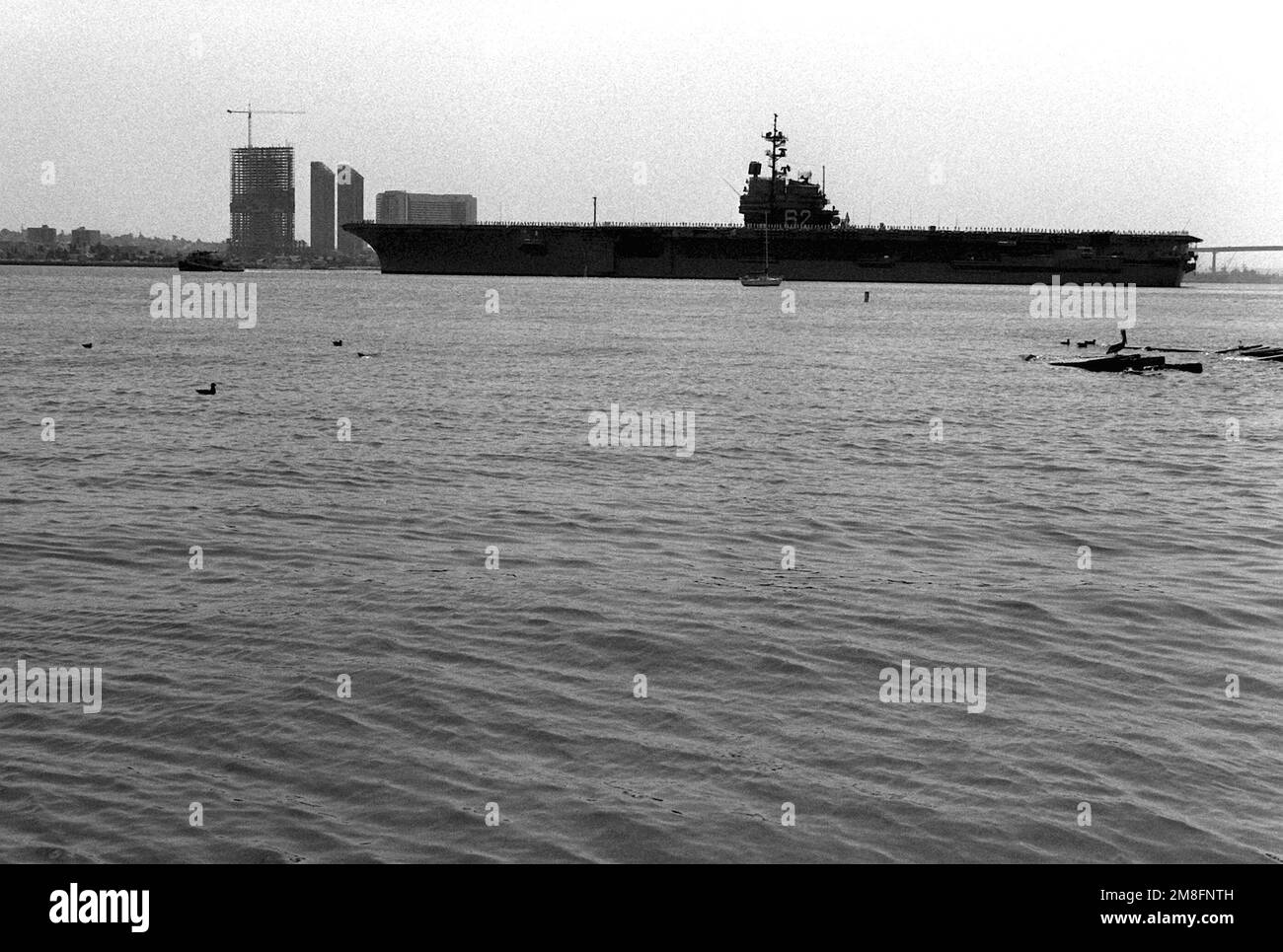 With its crew manning the rails, the aircraft carrier USS INDEPENDENCE ...