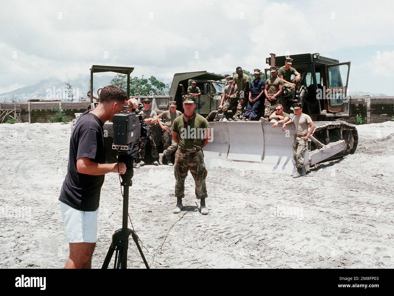 A Navy cameraman videotapes an interview with a member of a Marine ...