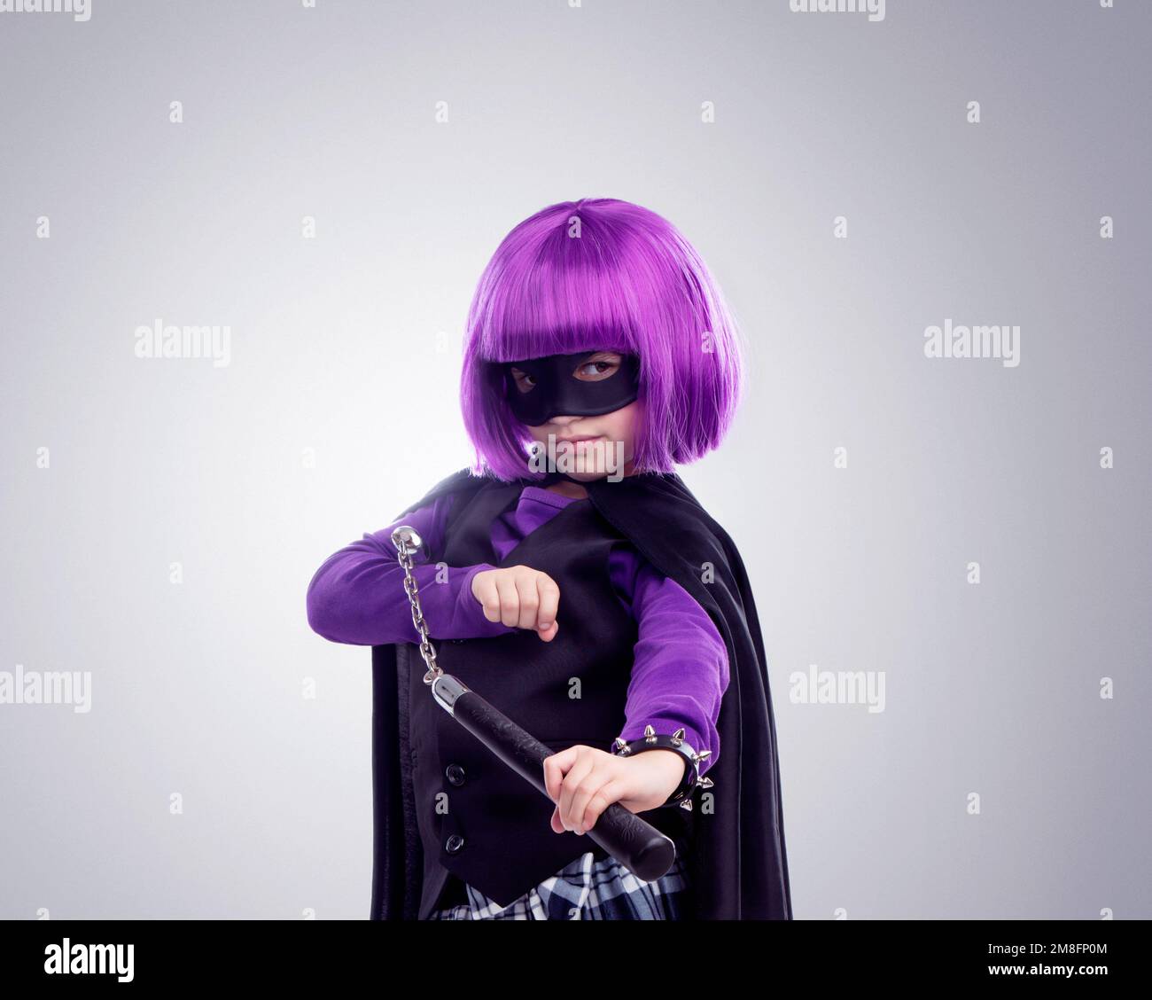 Kid, costume girl or vigilante in studio portrait with nunchaku ...