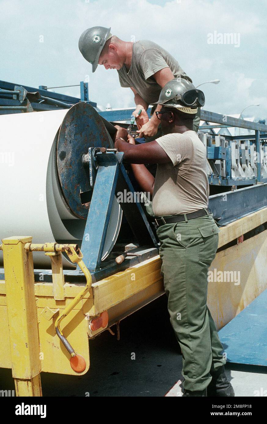 Two Seabees from Naval Mobile Construction Battalion 4 (NMCB-4) ready a ...