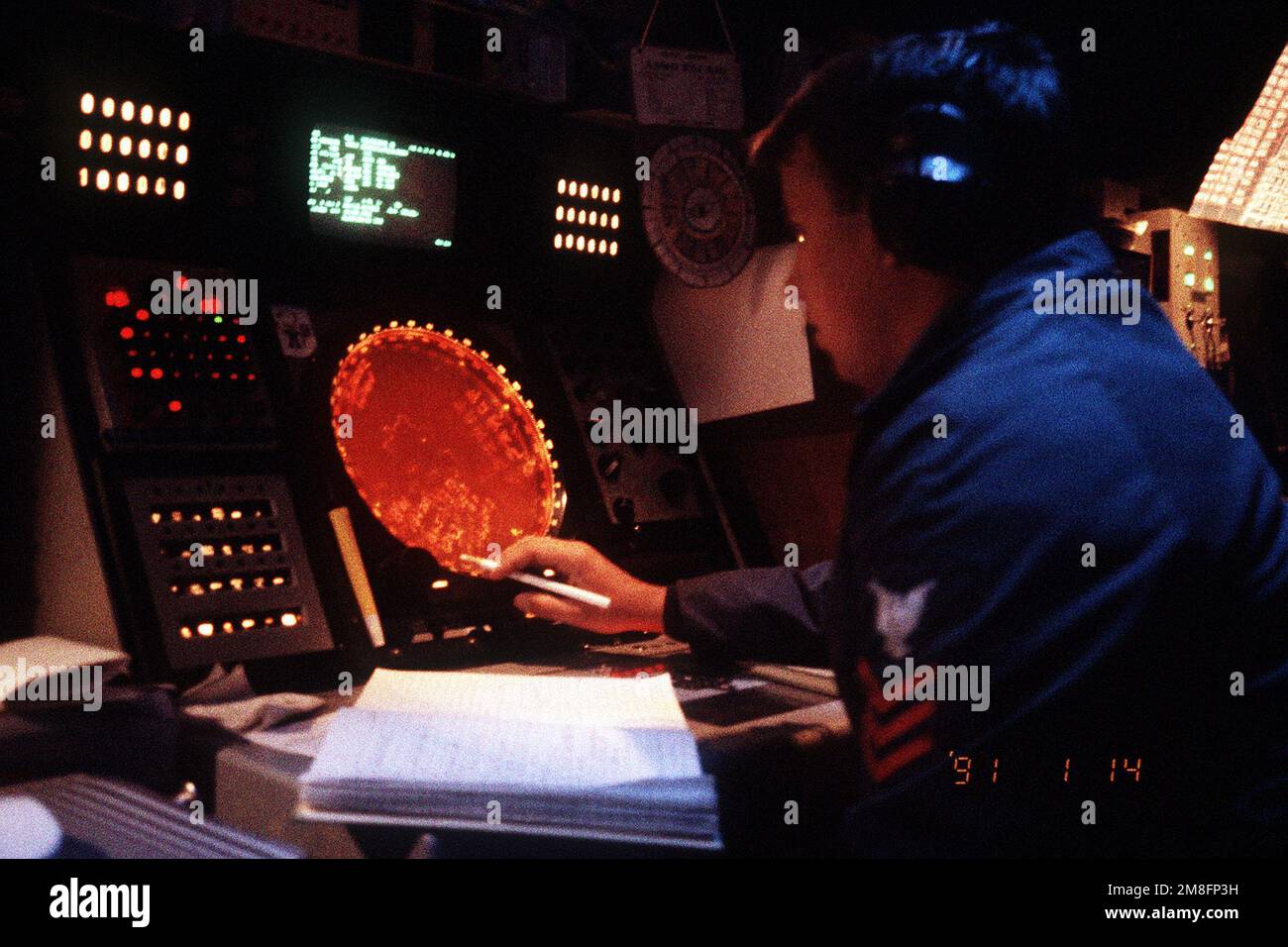 An air intercept controller monitors a radar screen in the combat ...