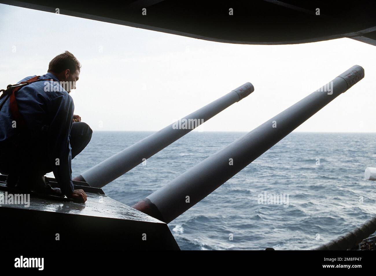 GUNNER's Mate SEAMAN Michael Keith scrubs the top of Mount 52, a Mark ...