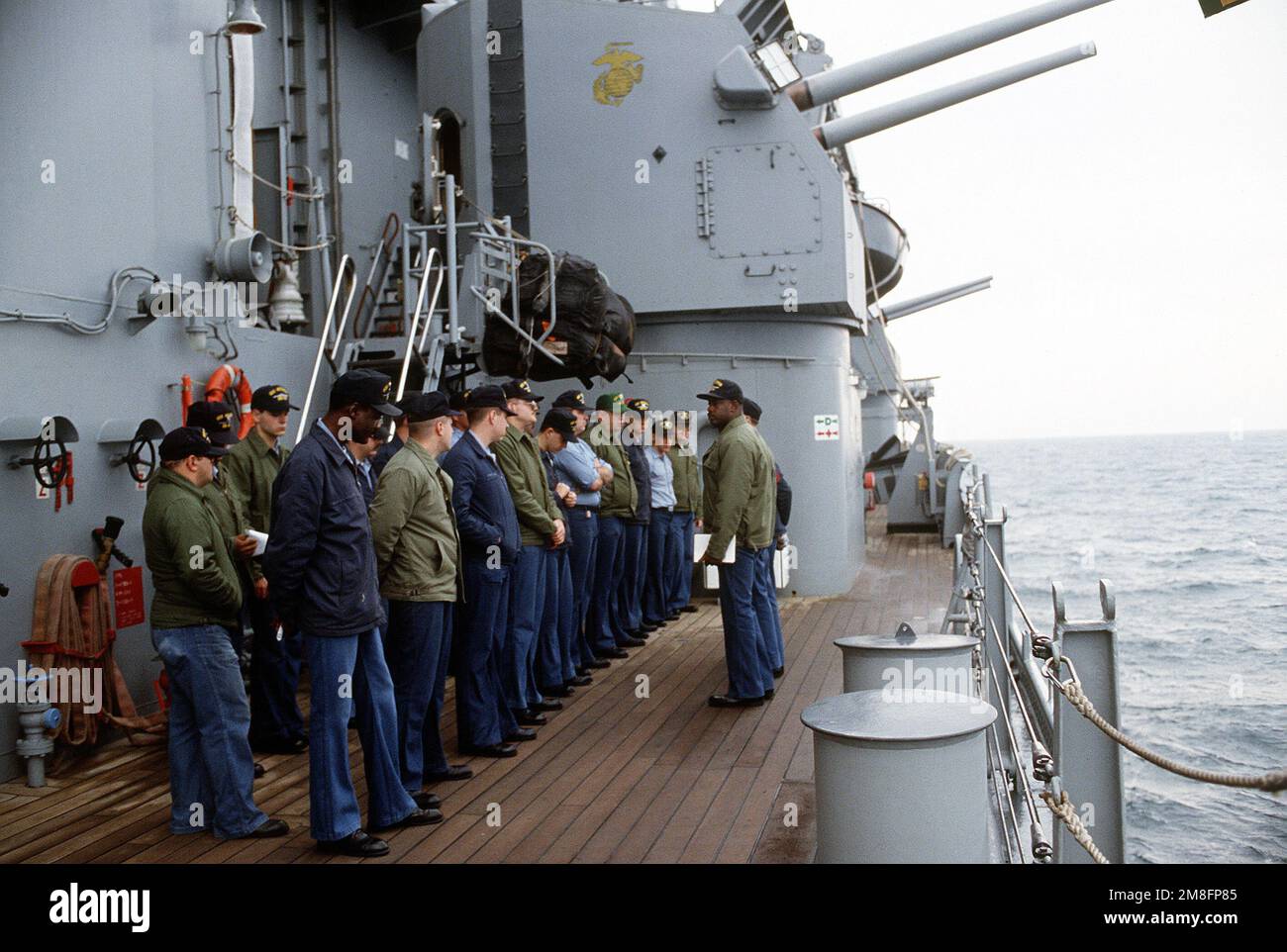 The sailors of Executive Division muster for quarters aboard the ...