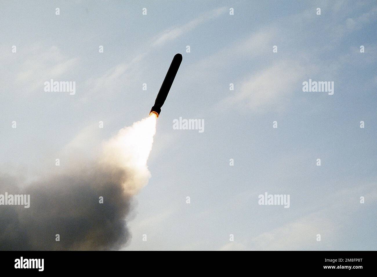 A plume of smoke trails behind a BGM-109 Tomahawk land-attack missile ...