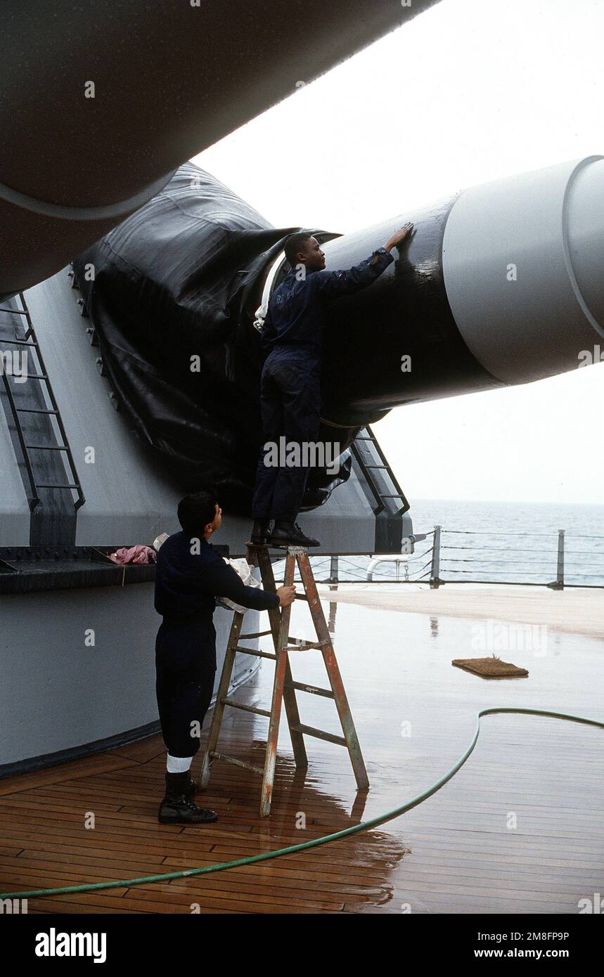 GUNNER's Mate 2nd Class Terodney Russell applies a coat of grease to ...