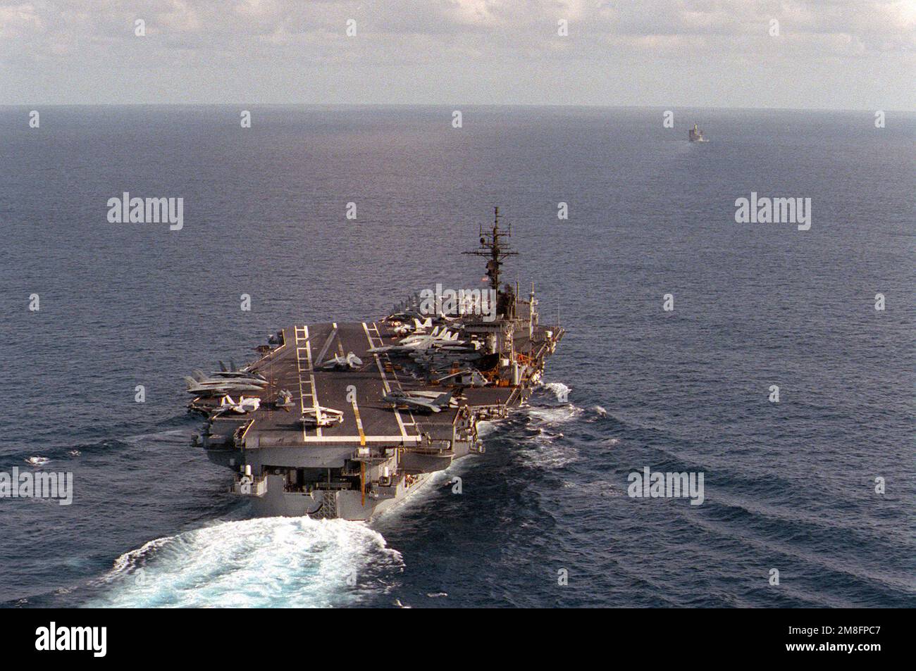 A stern view of the aircraft carrier USS KITTY HAWK (CV-63) underway ...