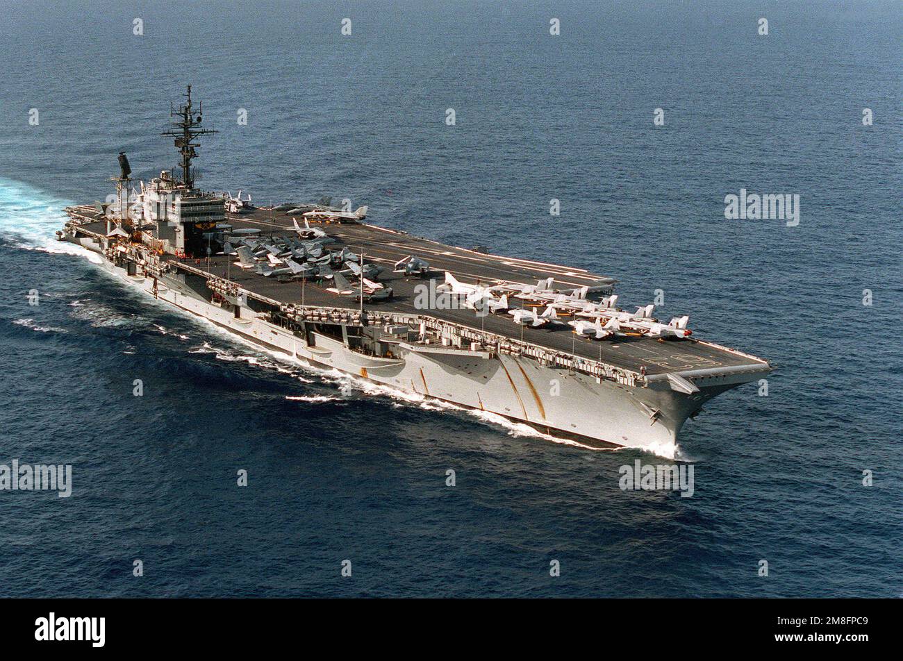 A starboard bow view of the aircraft carrier USS KITTY HAWK (CV-63 ...
