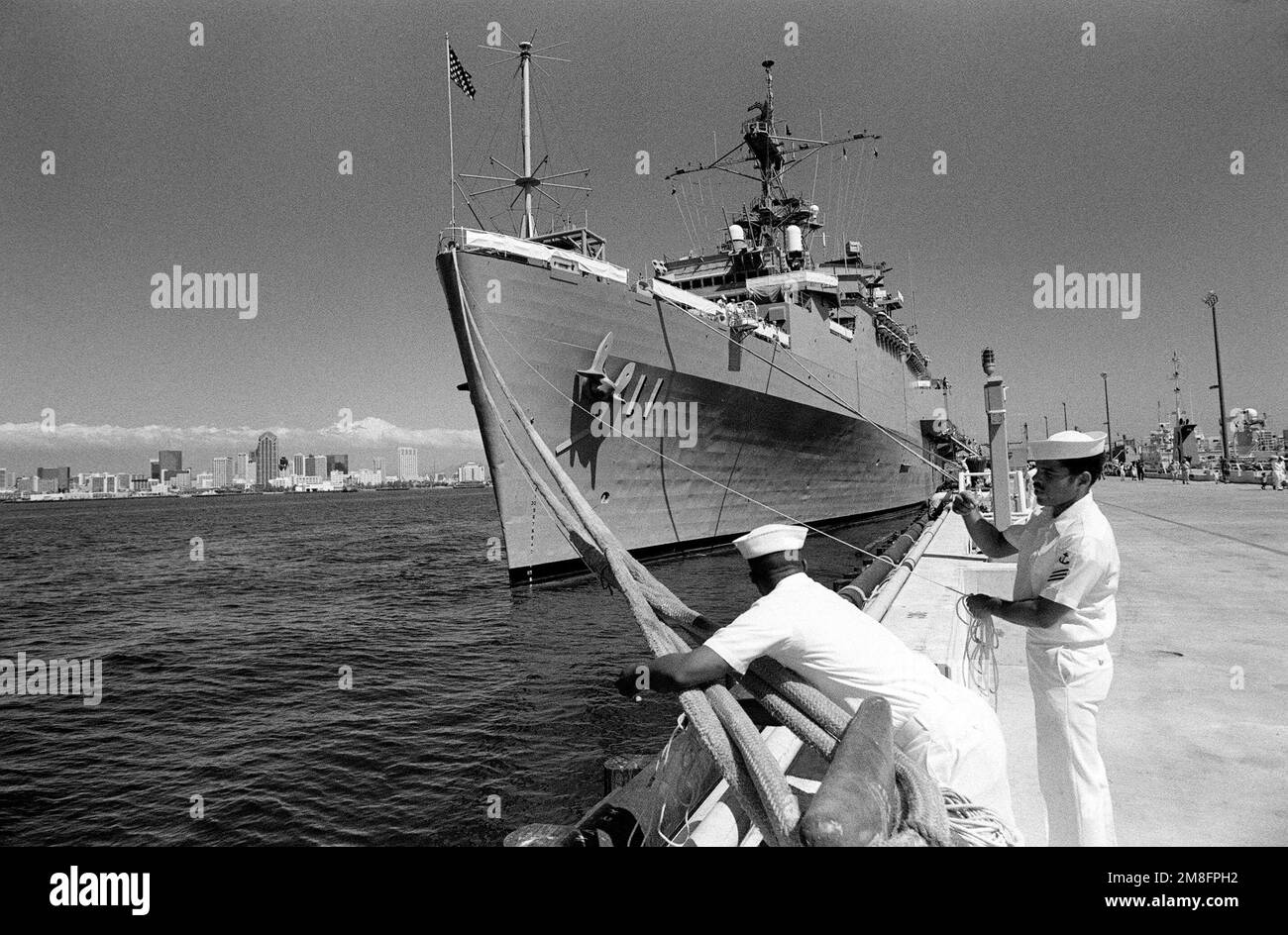 Line handlers secure the miscellaneous flagship USS CORONADO (AGF-11 ...