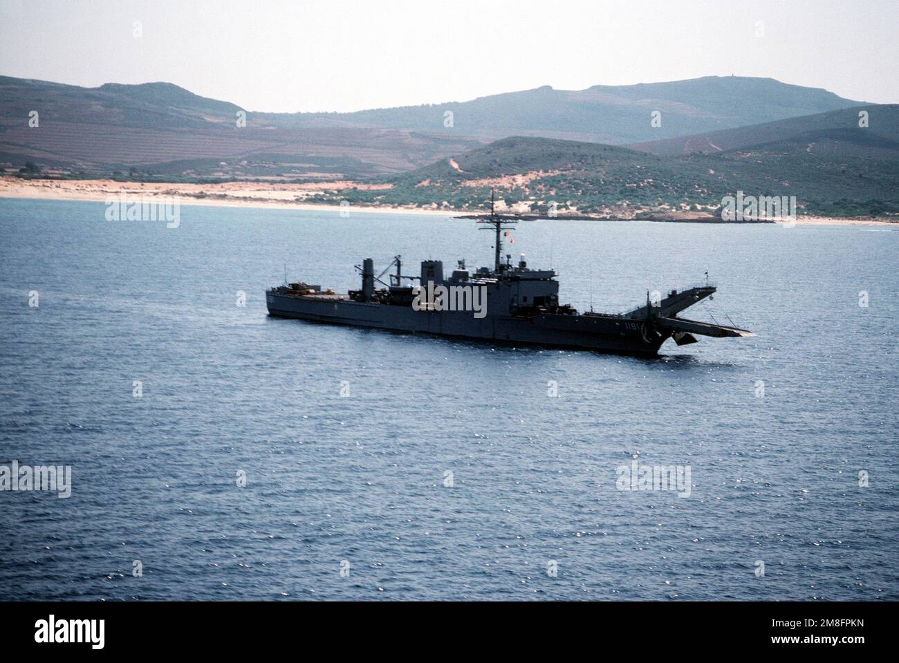 The tank landing ship USS SUMTER COUNTY (LST 1181), its bow ramp ...