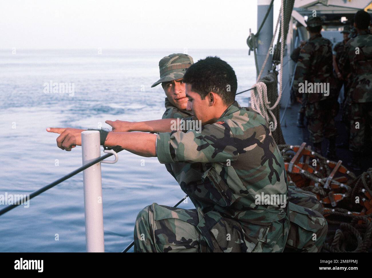 Ecuadoran marines relax aboard an amphibious ship as they wait to ...