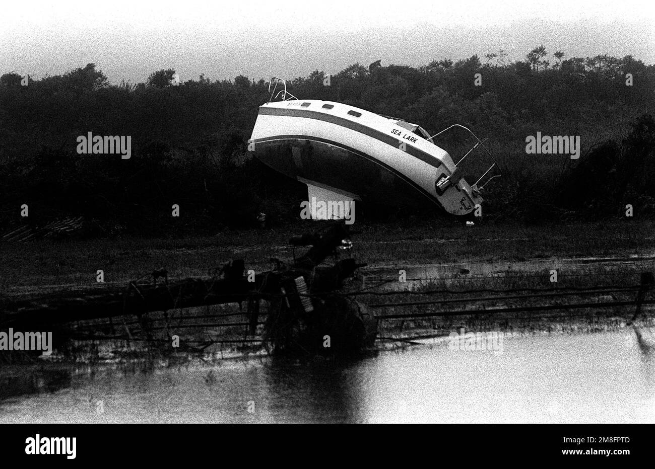 The sail boat Sea Lark lies on its side in a parking lot behind Navy ...