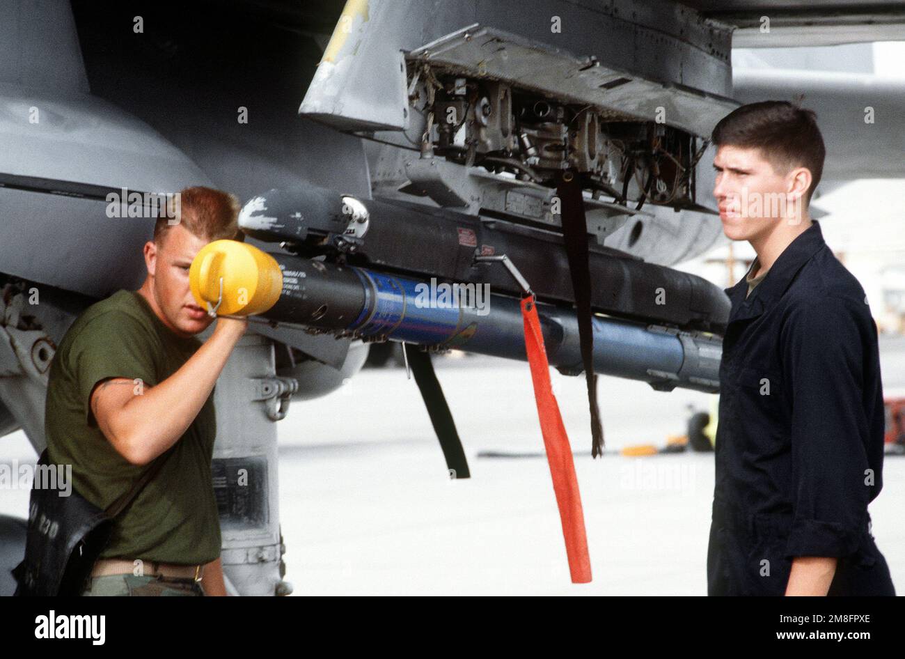 Members of Marine Attack Squadron 224 (VMA-224) inspect an AIM-9 ...
