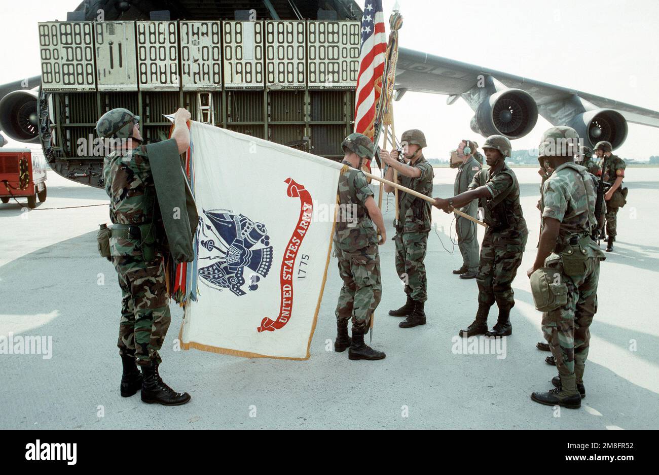 Members of a U.S. Army color guard prepare to take part in a ceremony ...