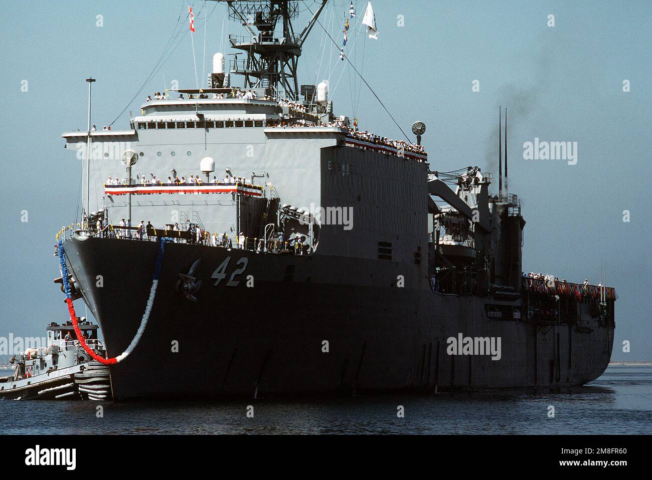 A garland decorates the bow of the dock landing ship USS GERMANTOWN ...