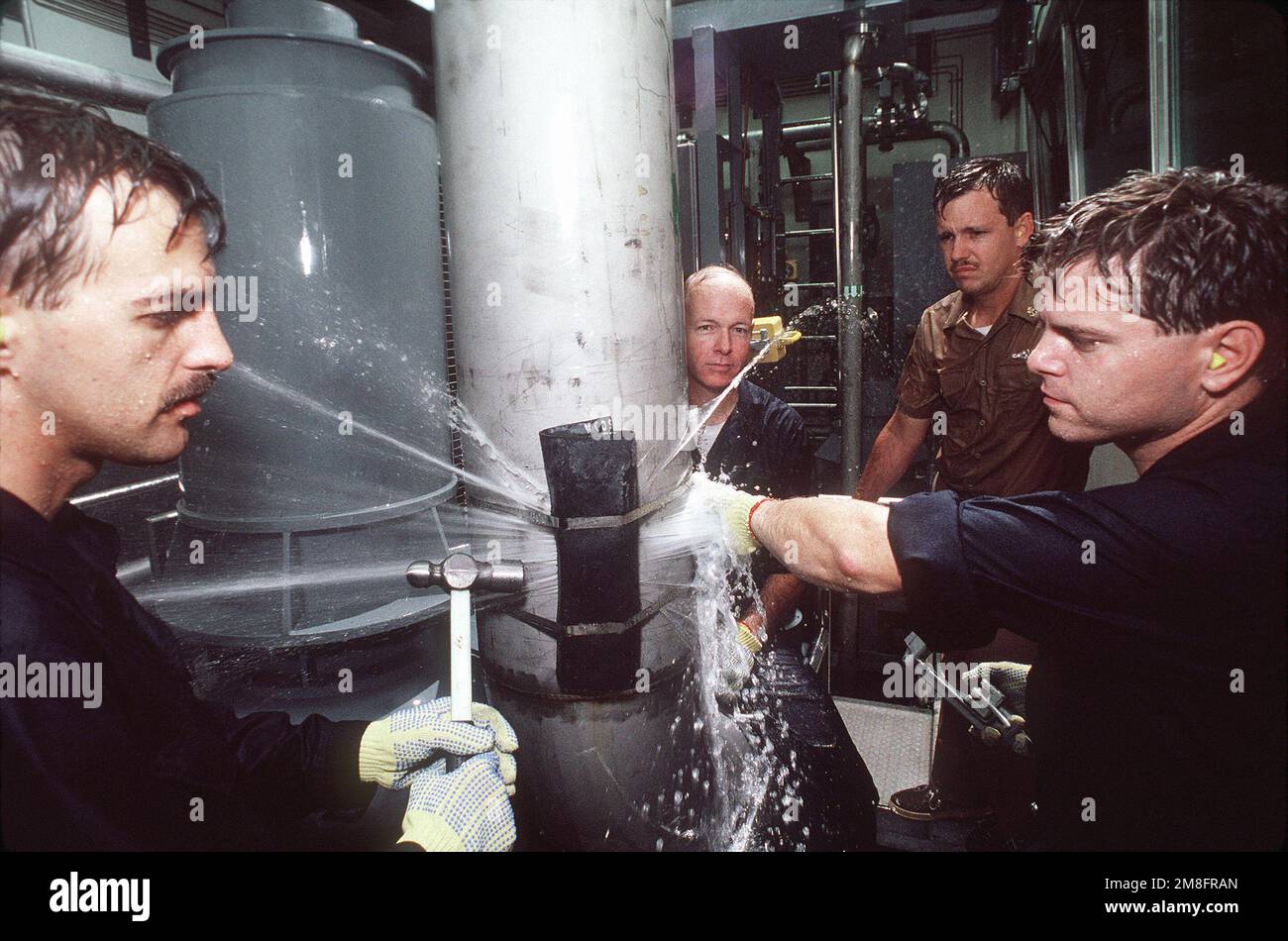 Young submariners are taught how to isolate a major leak in a submarine ...