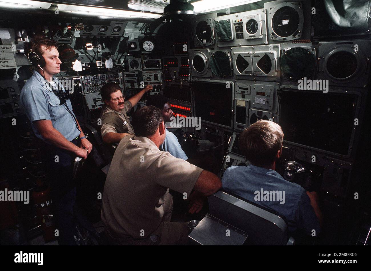 Crew members man the control station aboard the nuclear-powered attack ...