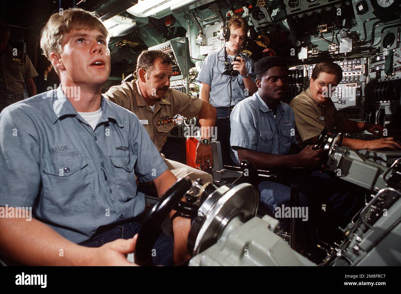 Crew members man the control station aboard the nuclear-powered attack ...