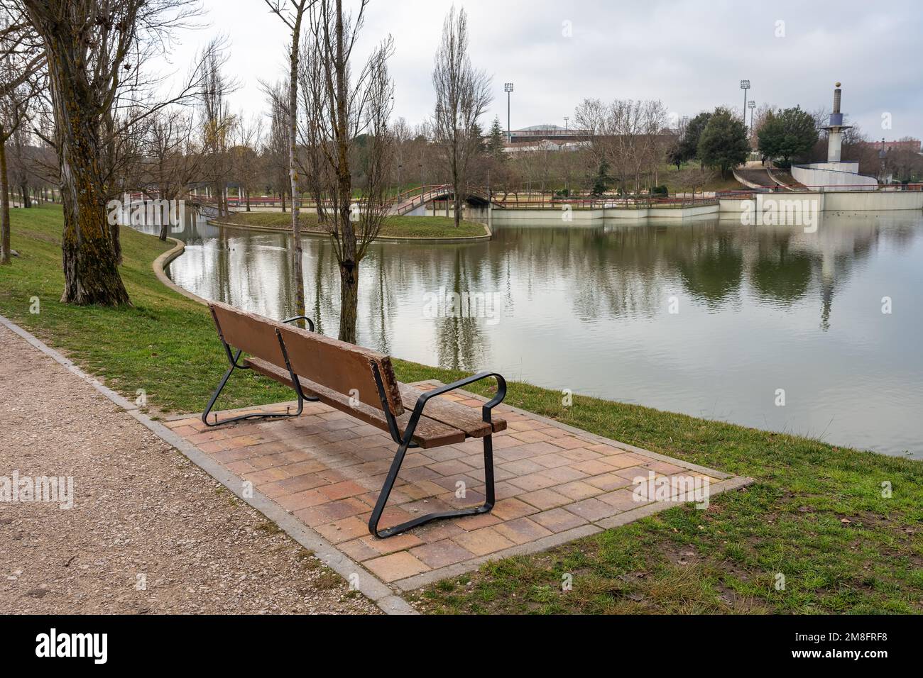 Wooden bench to sit and rest in a public park overlooking the crystal ...