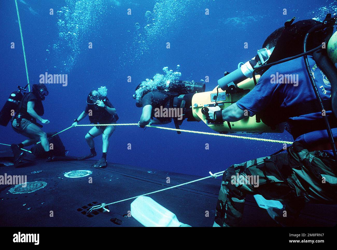 Photographer's Mate (Diver) 2nd Class Greg Slater, right, videotapes ...