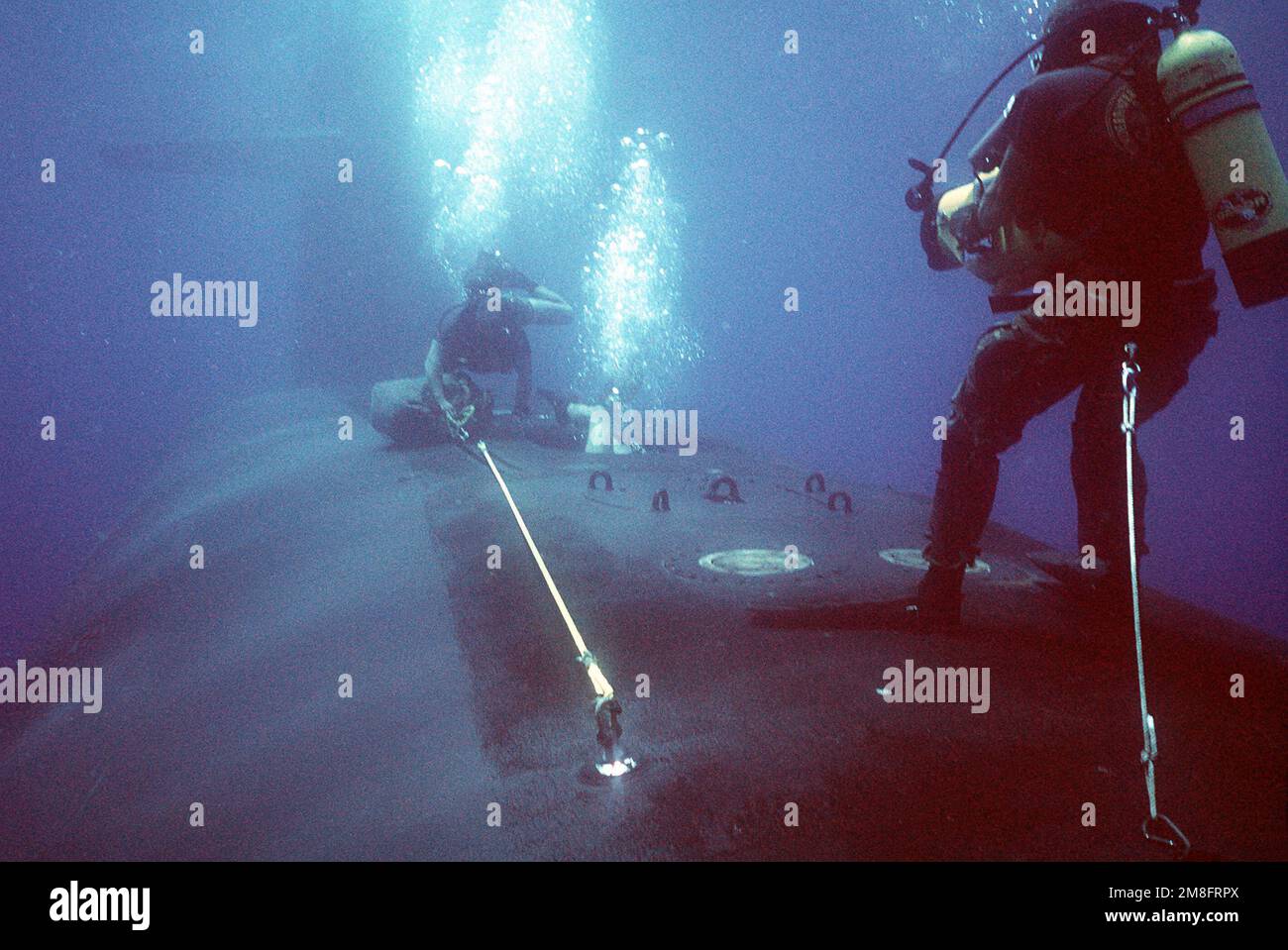 Photographer's Mate (Diver) 2nd Class David Tilton, right, videotapes ...