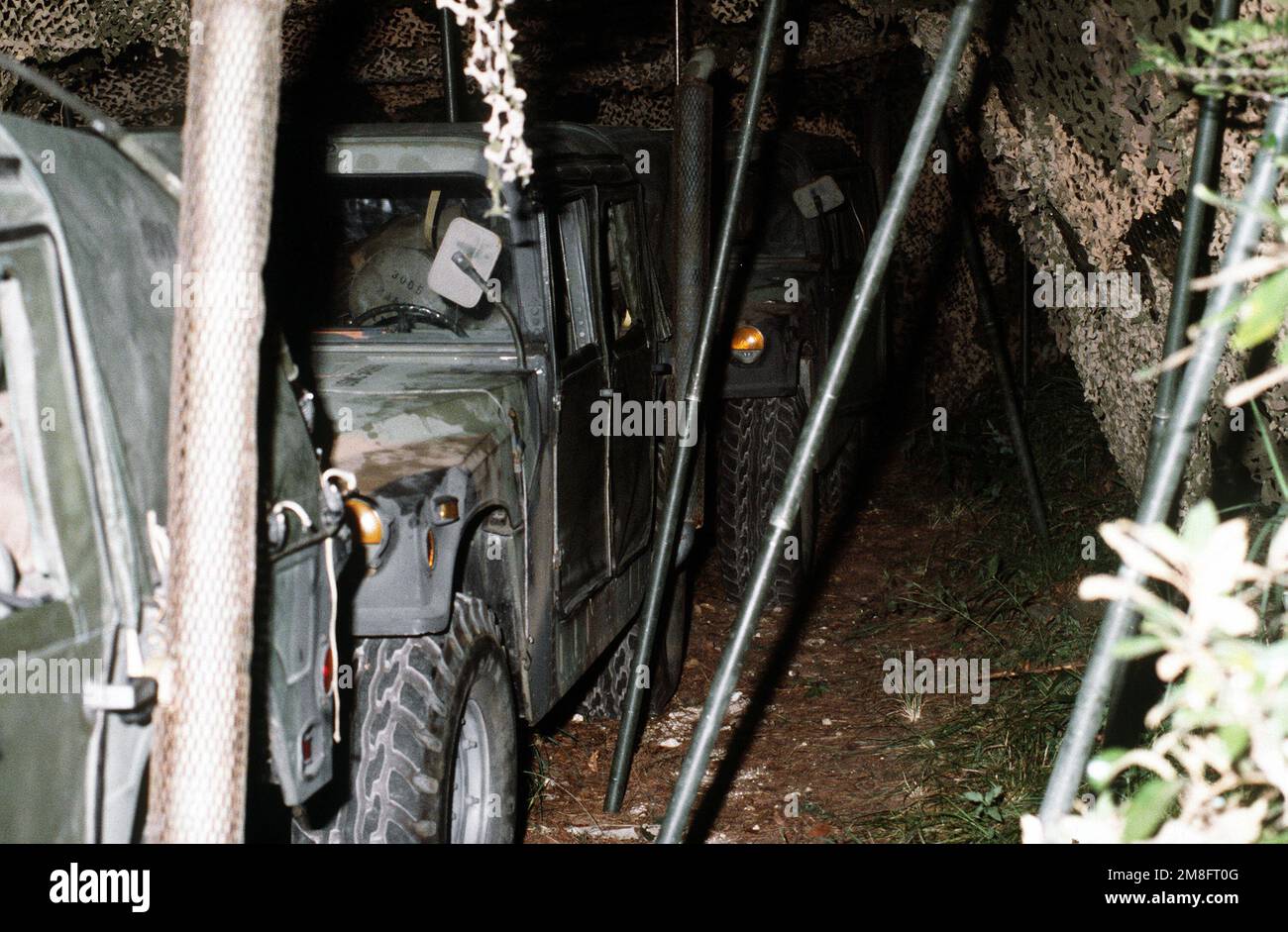 M998 High-Mobility Multipurpose Wheeled Vehicles (HMMWV) are positioned ...