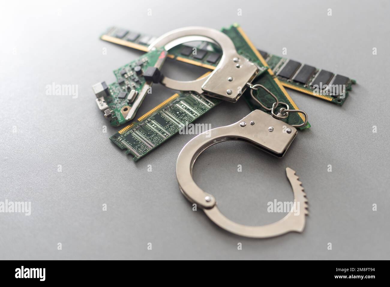 Digital security concept: handcuffs on the background of a computer ...