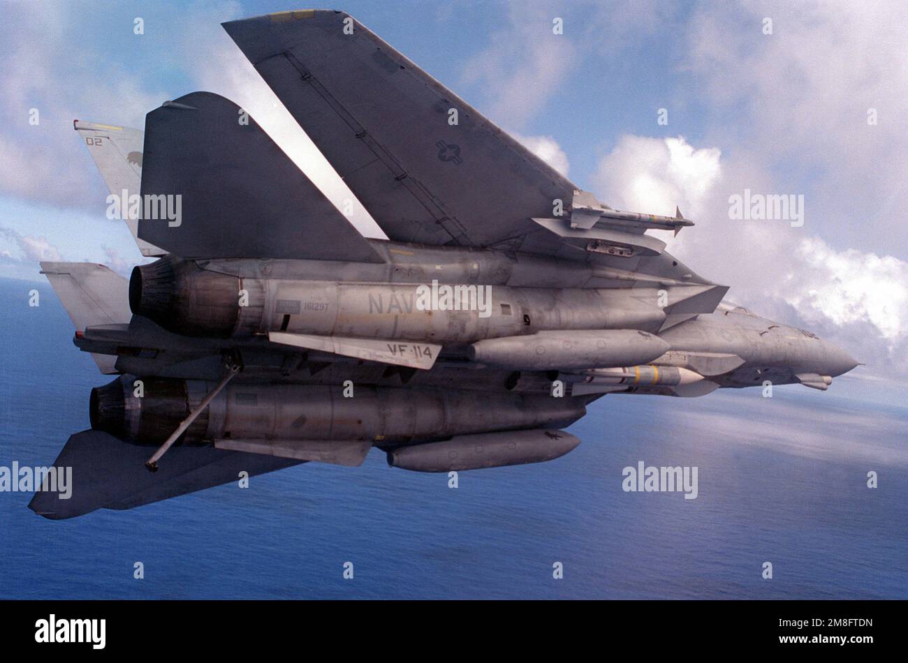 An air-to-air underside view of a Fighter Squadron 114 (VF-114) F-14A ...