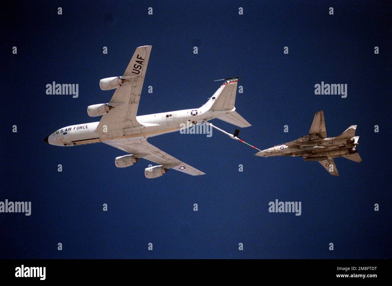 A Fighter Squadron 114 (VF-114) F-14A Tomcat aircraft refuels from an ...