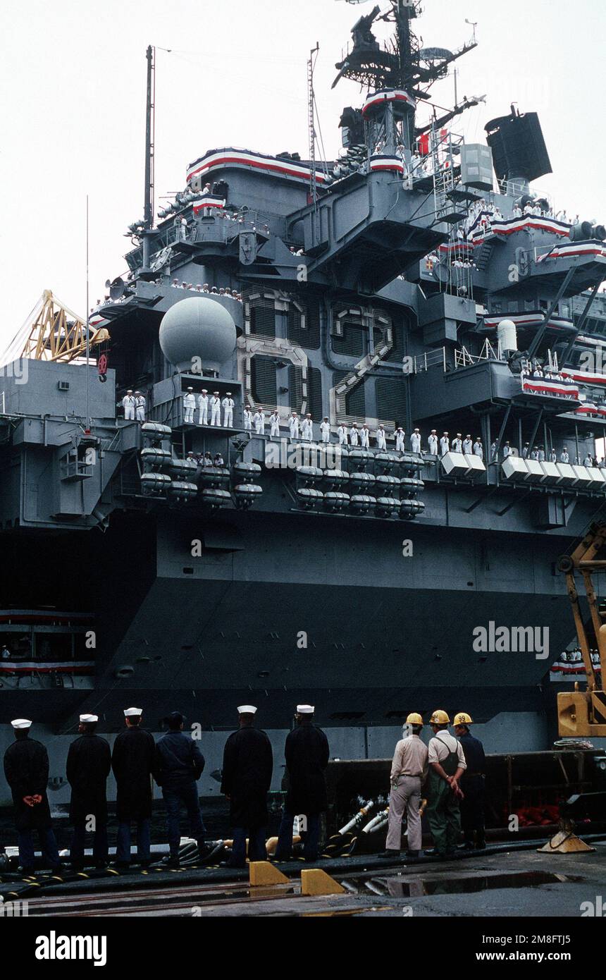 Line handlers stand by as the pier as the aircraft carrier USS ...