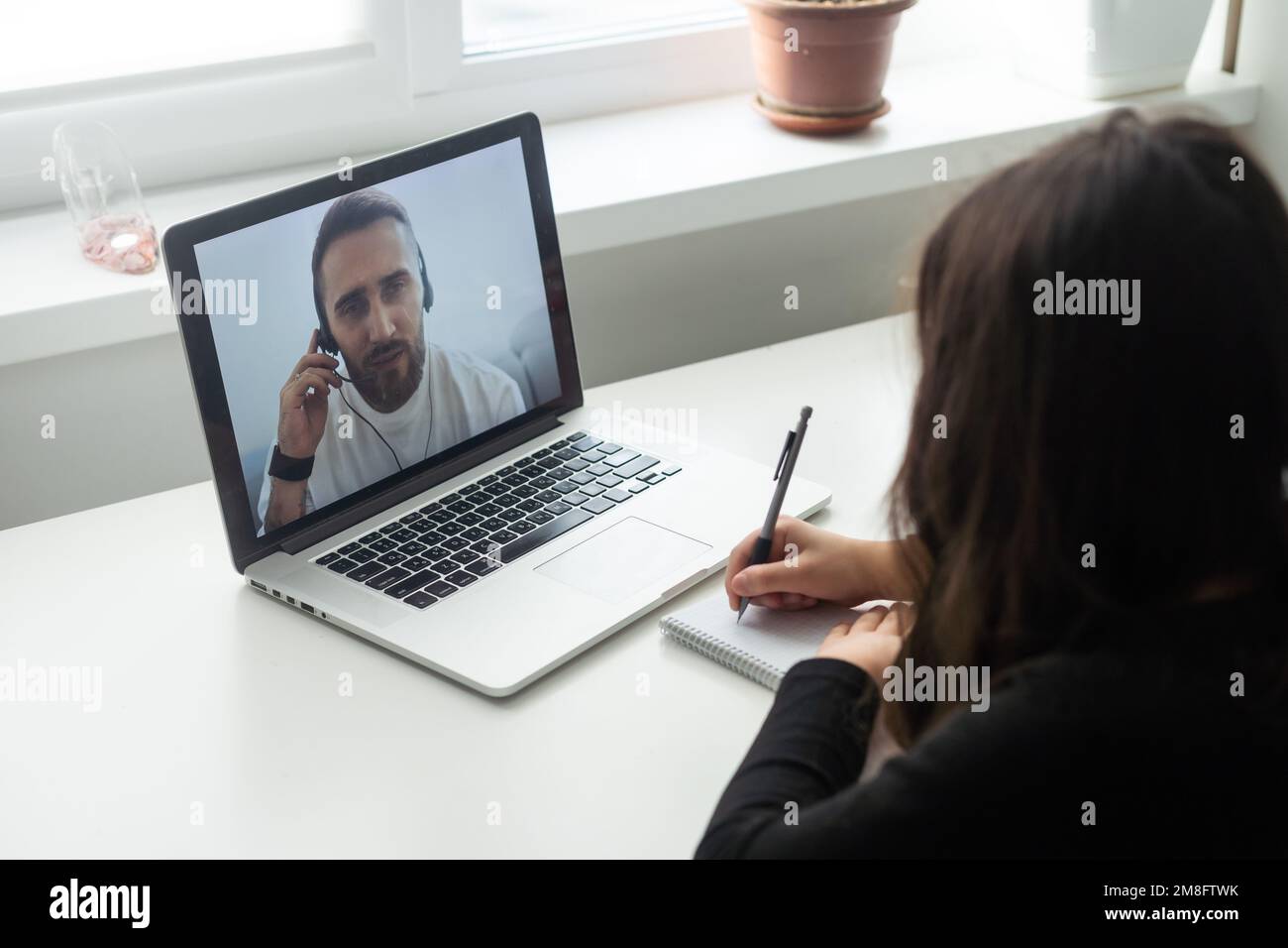 Smiling young teen schoolgirl involved in video web camera call on ...