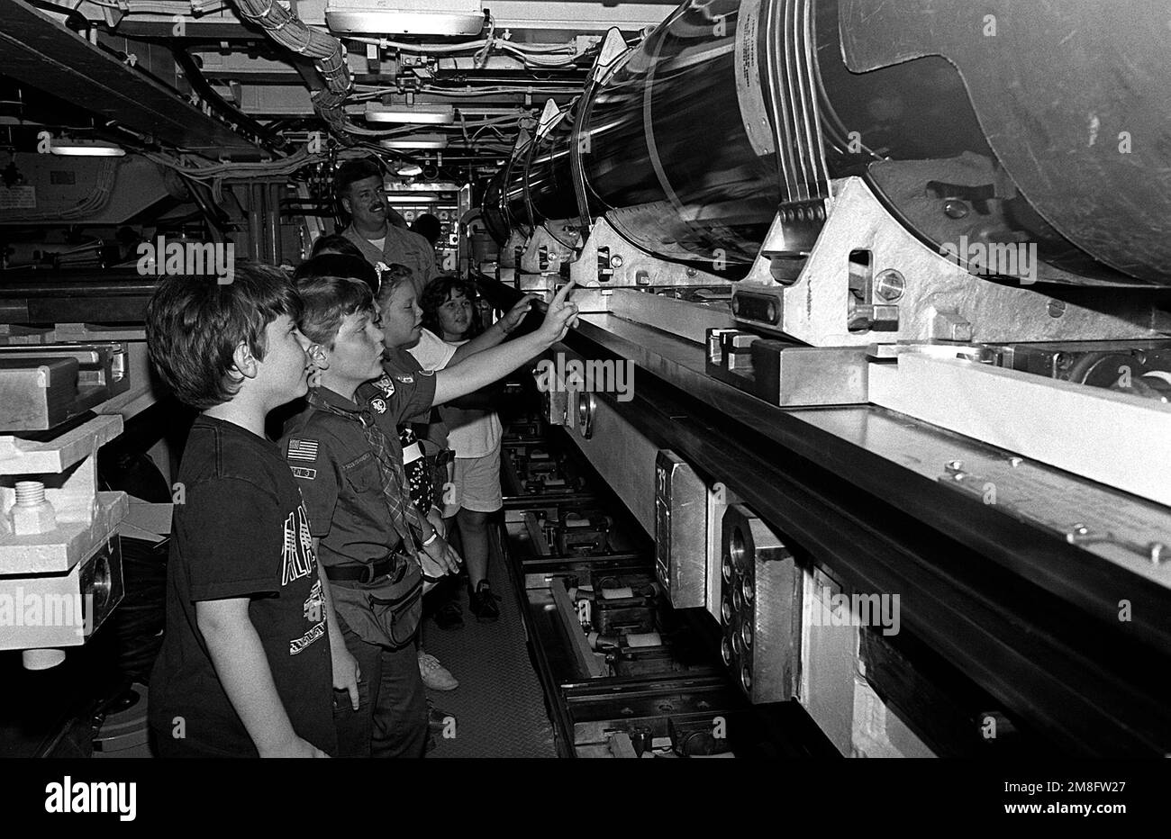Students explore the torpedo room aboard the nuclear-powered strategic ...