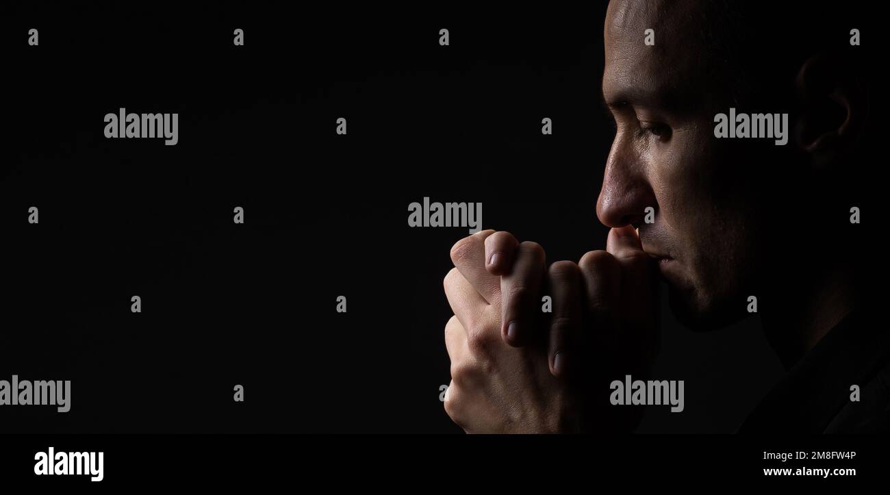 Portrait of a handsome man praying over gray background Stock Photo - Alamy