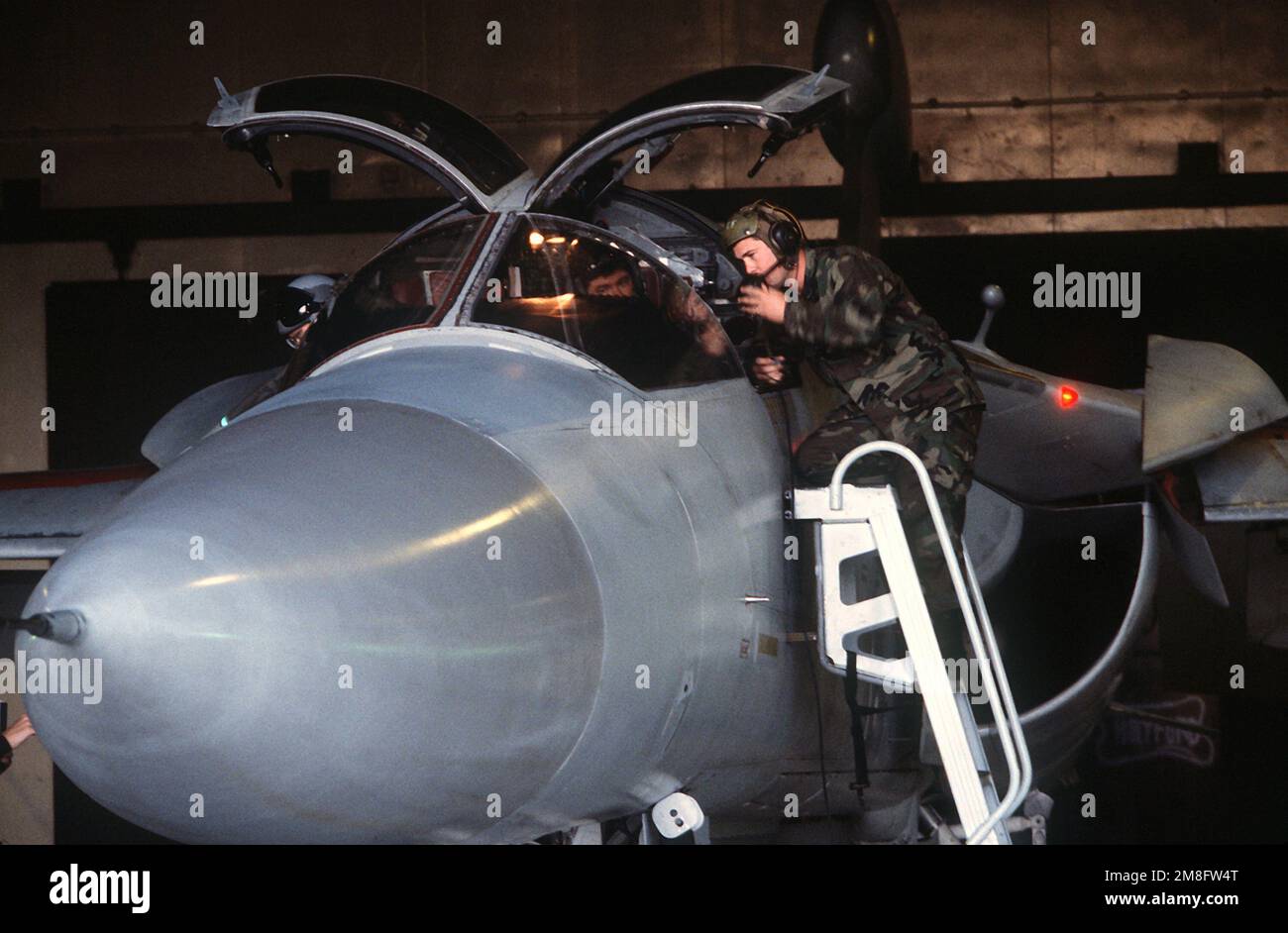 A crew chief from the 42nd Electronic Combat Squadron talks with CAPT ...