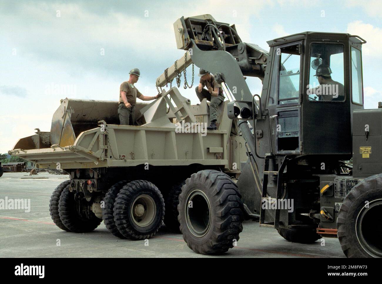 Two Seabees from Naval Mobile Cosntruction Battalion 4 (NMCB-4) signal ...