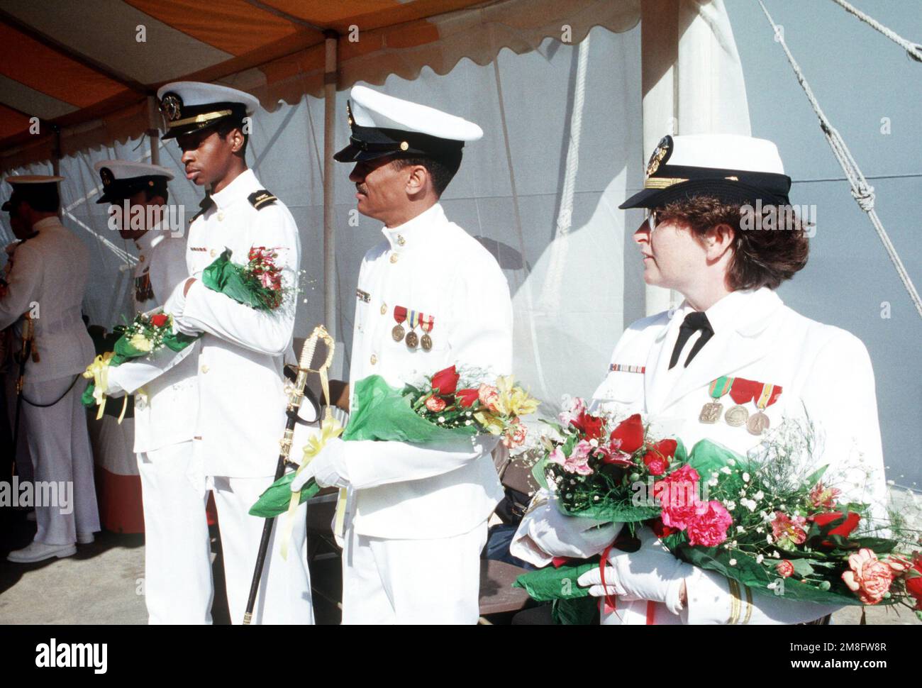 Crew members of the repair ship USS VULCAN (AR-5) stand by following ...