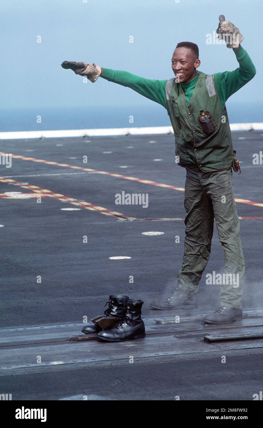 Aviation Boatswain's Mate 3rd Class Ronnie Josey jokingly gives the ...