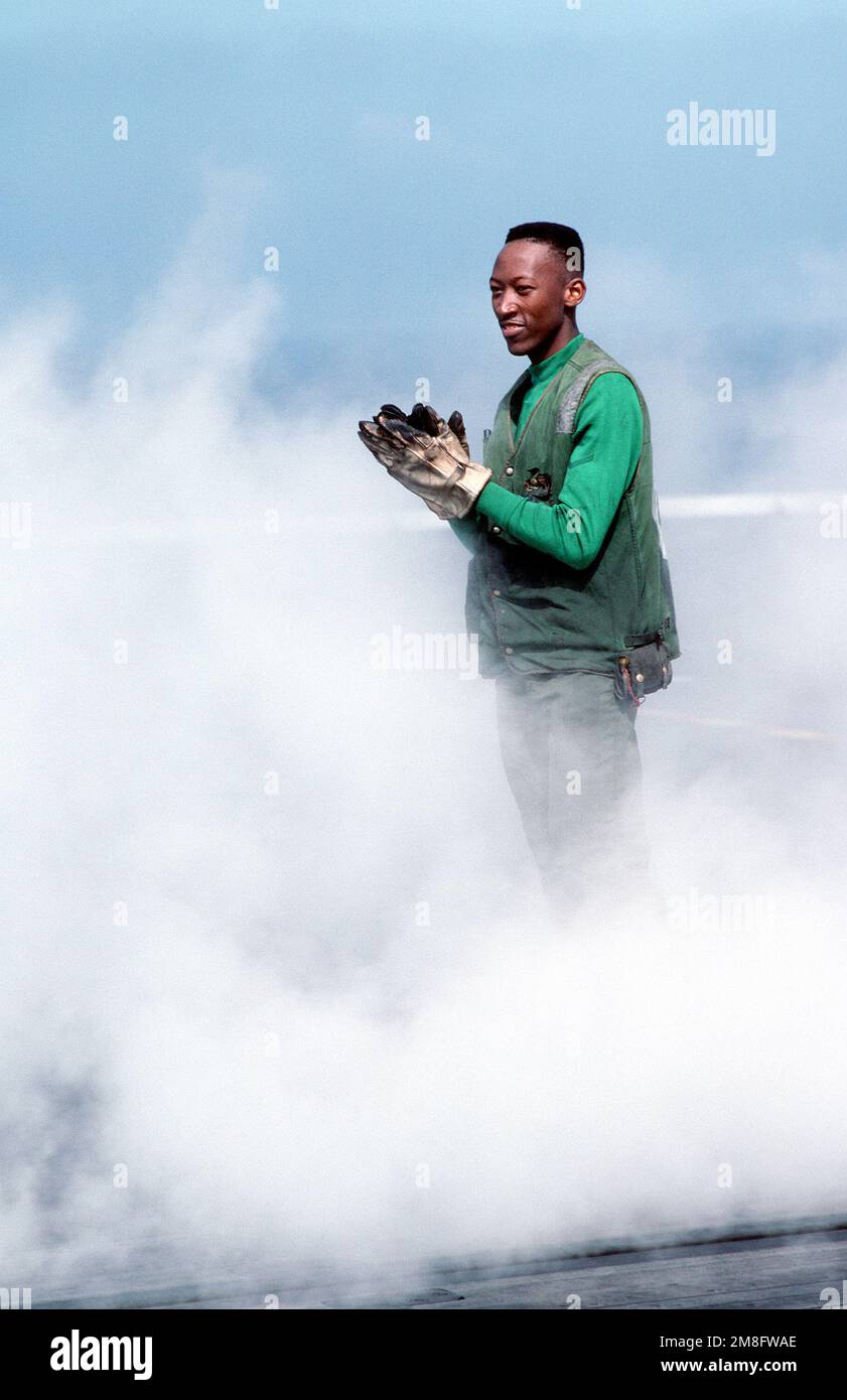 Aviation Boatswain's Mate 3rd Class Ronnie Josey applauds, after ...