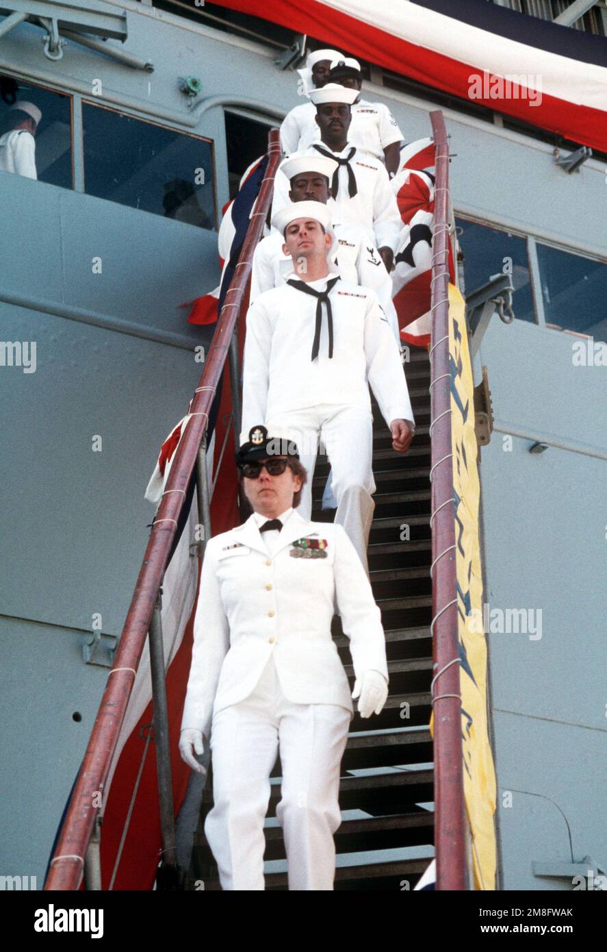 Crew members disembark from the repair ship USS VULCAN (AR-5) during ...
