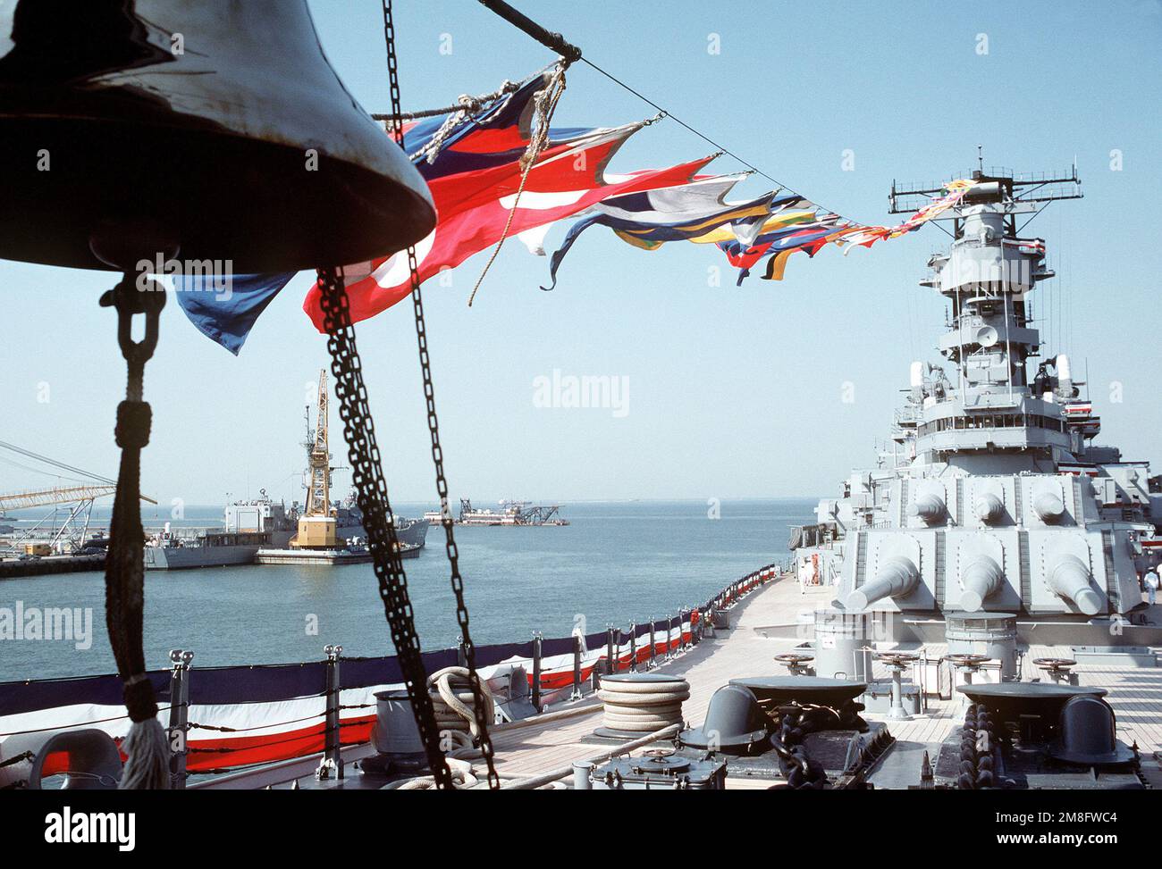 Bunting decorates the railing as ship's pennants fly aboard the ...